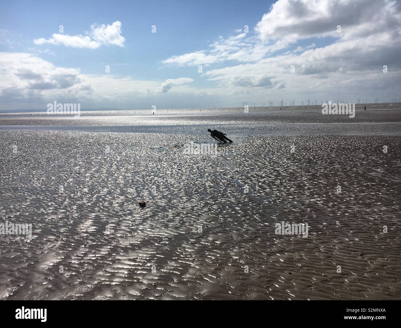 Iron Man at an angle on Crosby Beach, Liverpool, Merseyside, UK Stock ...