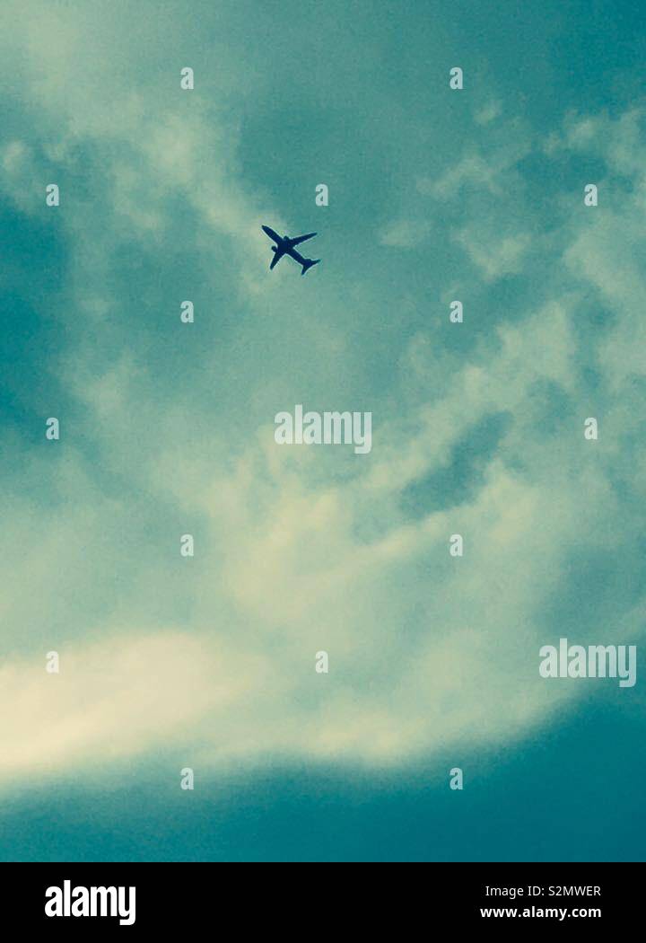 A plane taking off high in the sky Stock Photo - Alamy