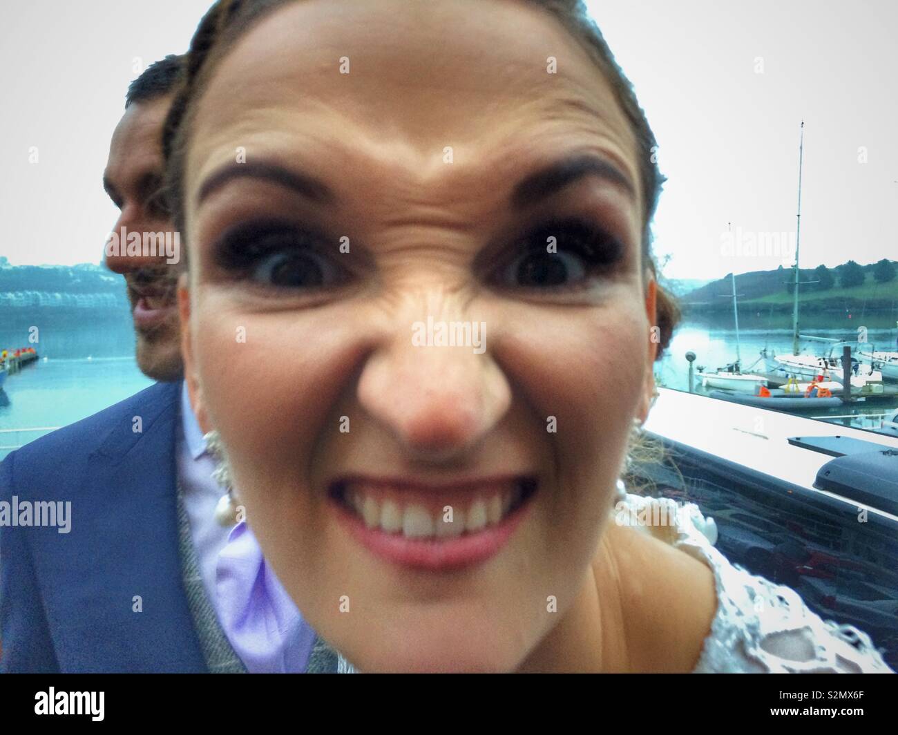 Girl in front of man, pulling silly face Stock Photo - Alamy