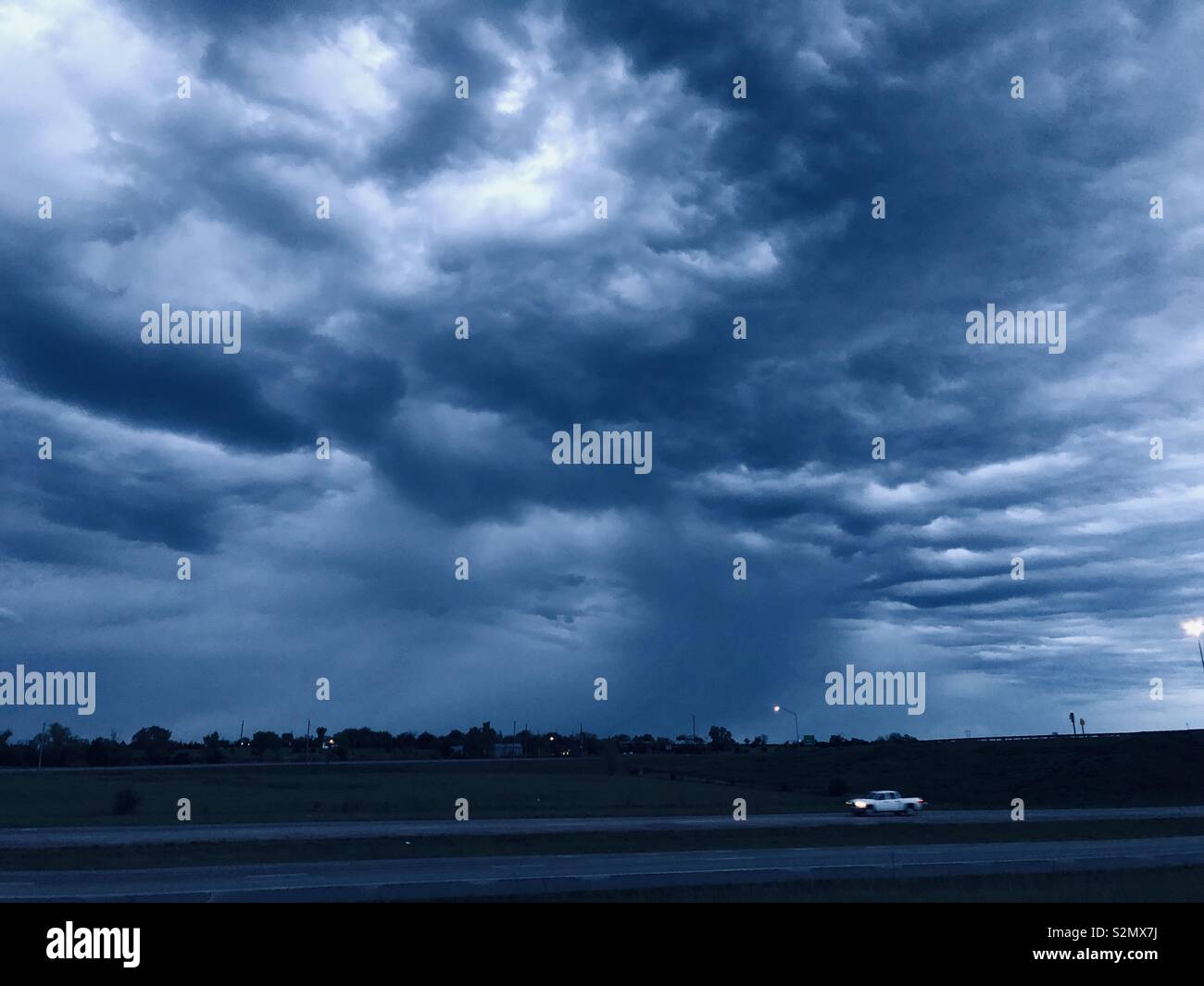 Early morning drive time rain clouds rolling in Stock Photo - Alamy