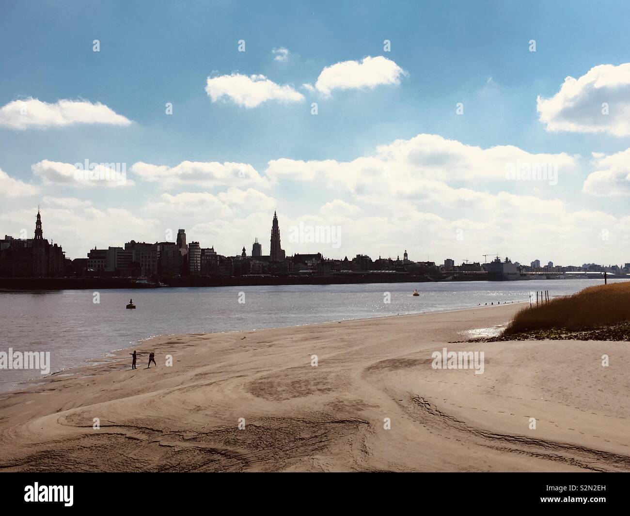 People playing on Saint-Anne Beach with Antwerp skyline Stock Photo - Alamy