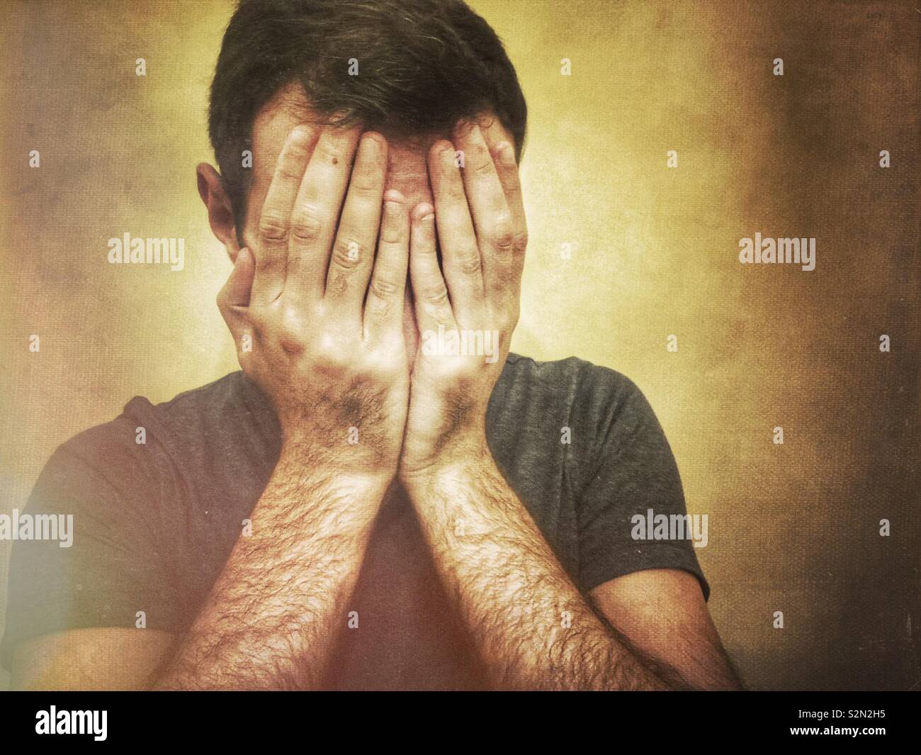 Scared man hiding face with hands Stock Photo - Alamy