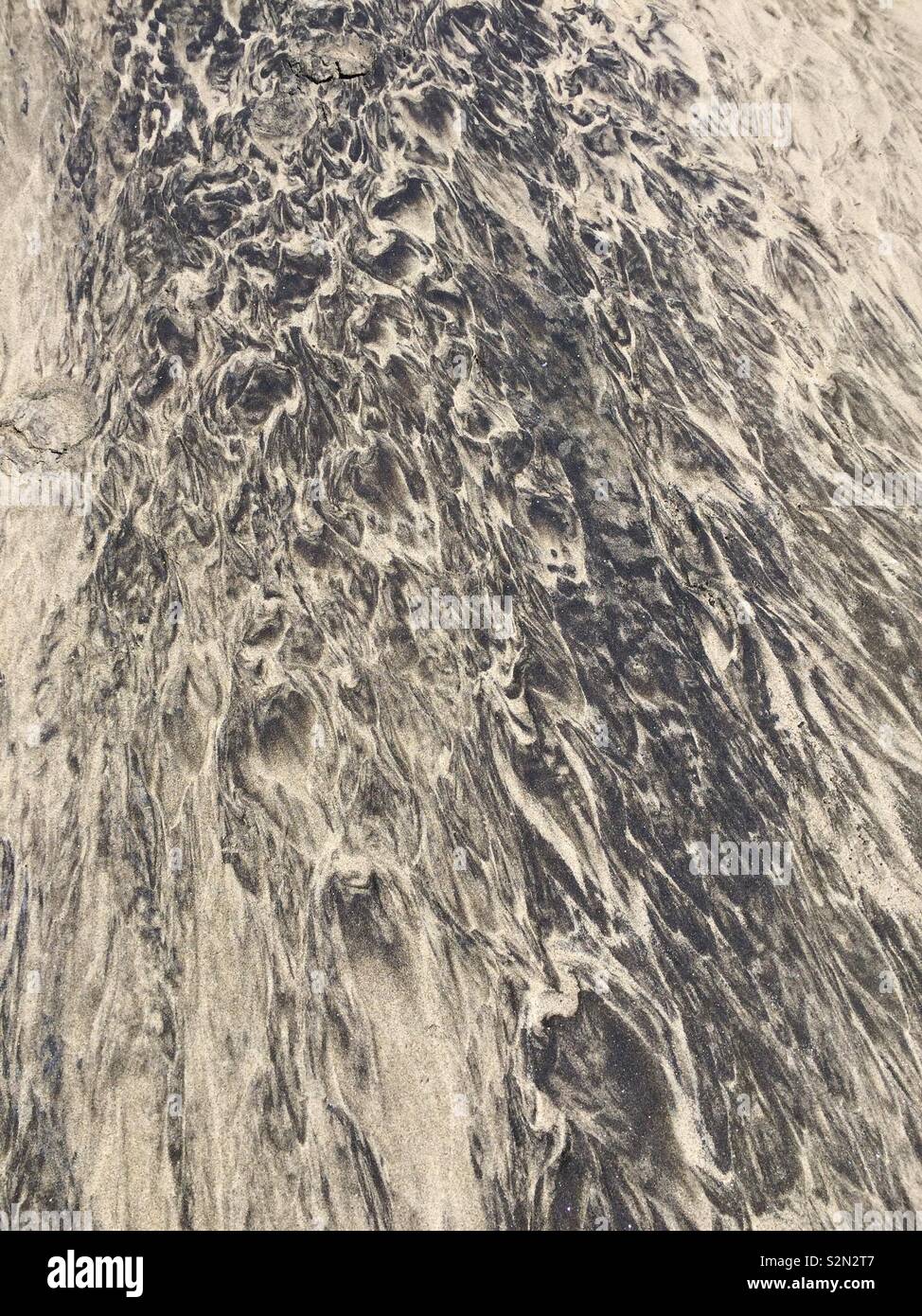 Tar pattern in the sand Stock Photo - Alamy