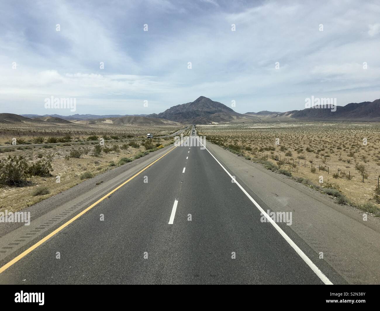 Straight section of freeway through the Mojave Desert, heading west ...