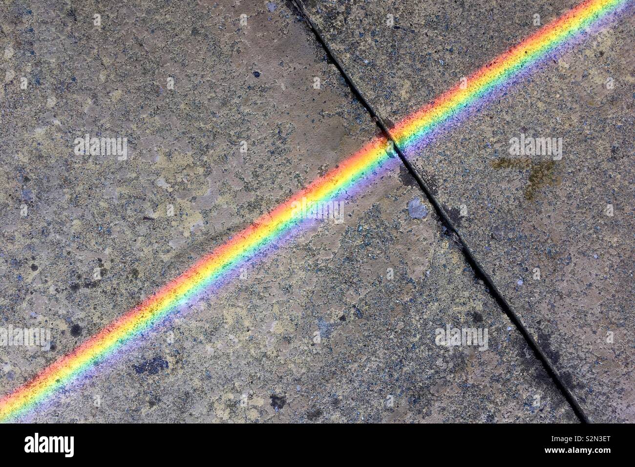 Rainbow on a Paving Stone Stock Photo - Alamy