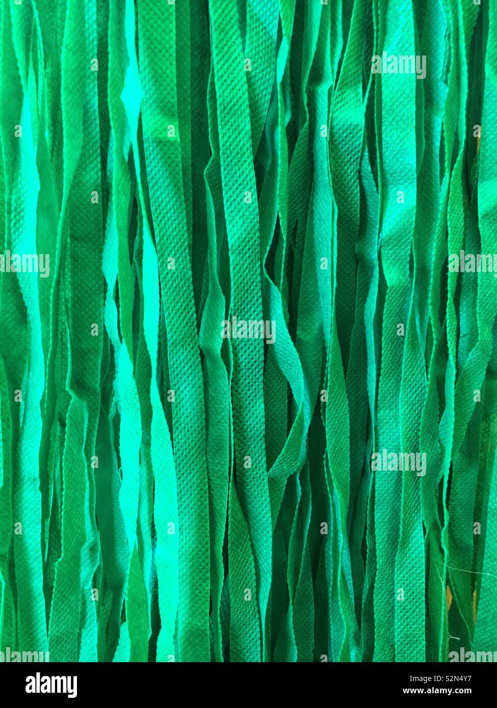 Full frame of green shoe strings hanging from the top to the bottom ...