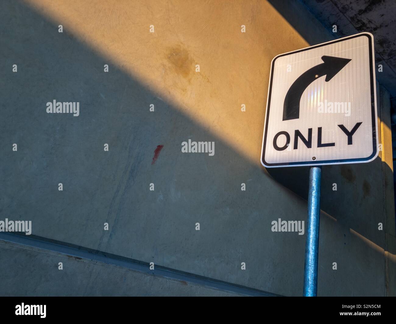 Direct sign with an arrow and the word only Stock Photo - Alamy