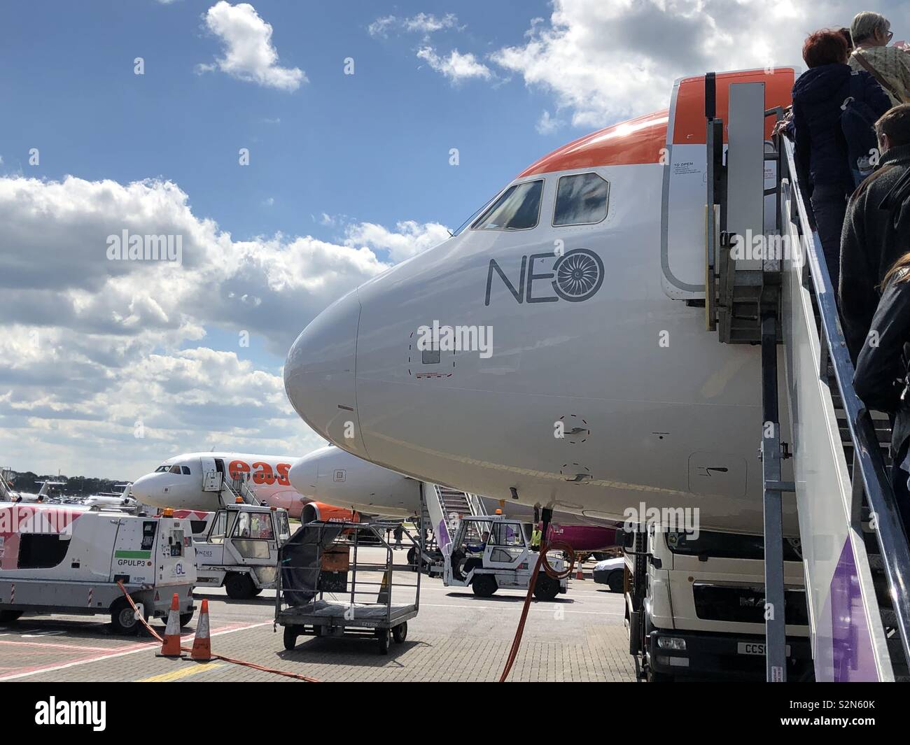Three EasyJet aircraft lined won the tarmac at Luton Airport taking ...