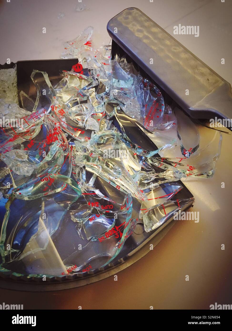 Dustpan and brush cleaning up a broken Pyrex measuring cup, USA Stock ...