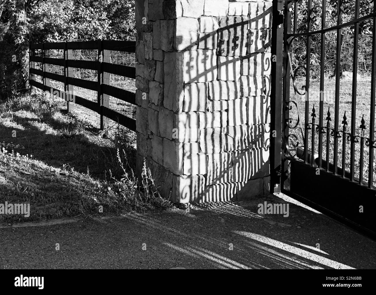 Horizontal and vertical fence and gate lines and shadows on a stone ...