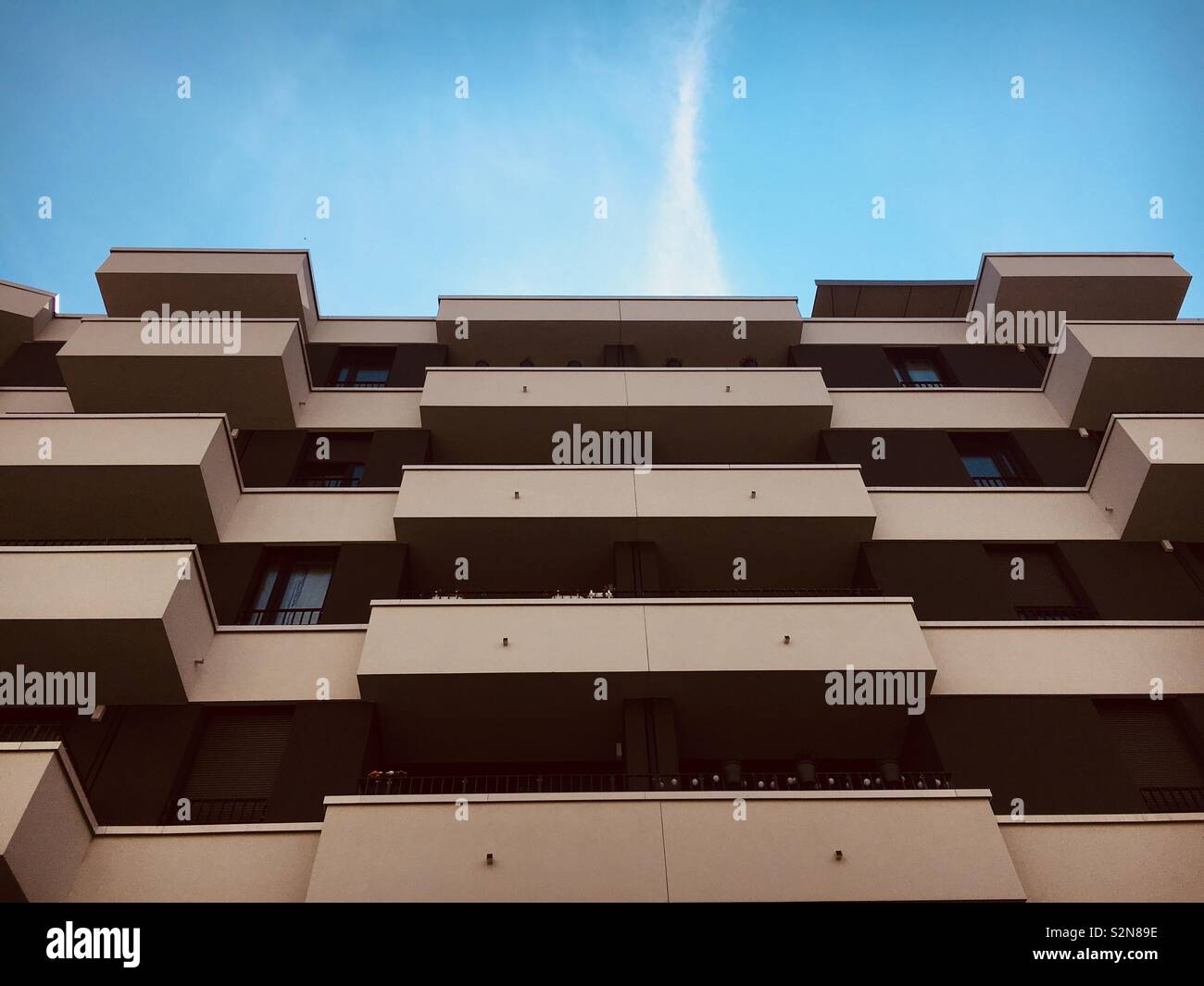 Apartment building with similar structure on clear blue sky background ...