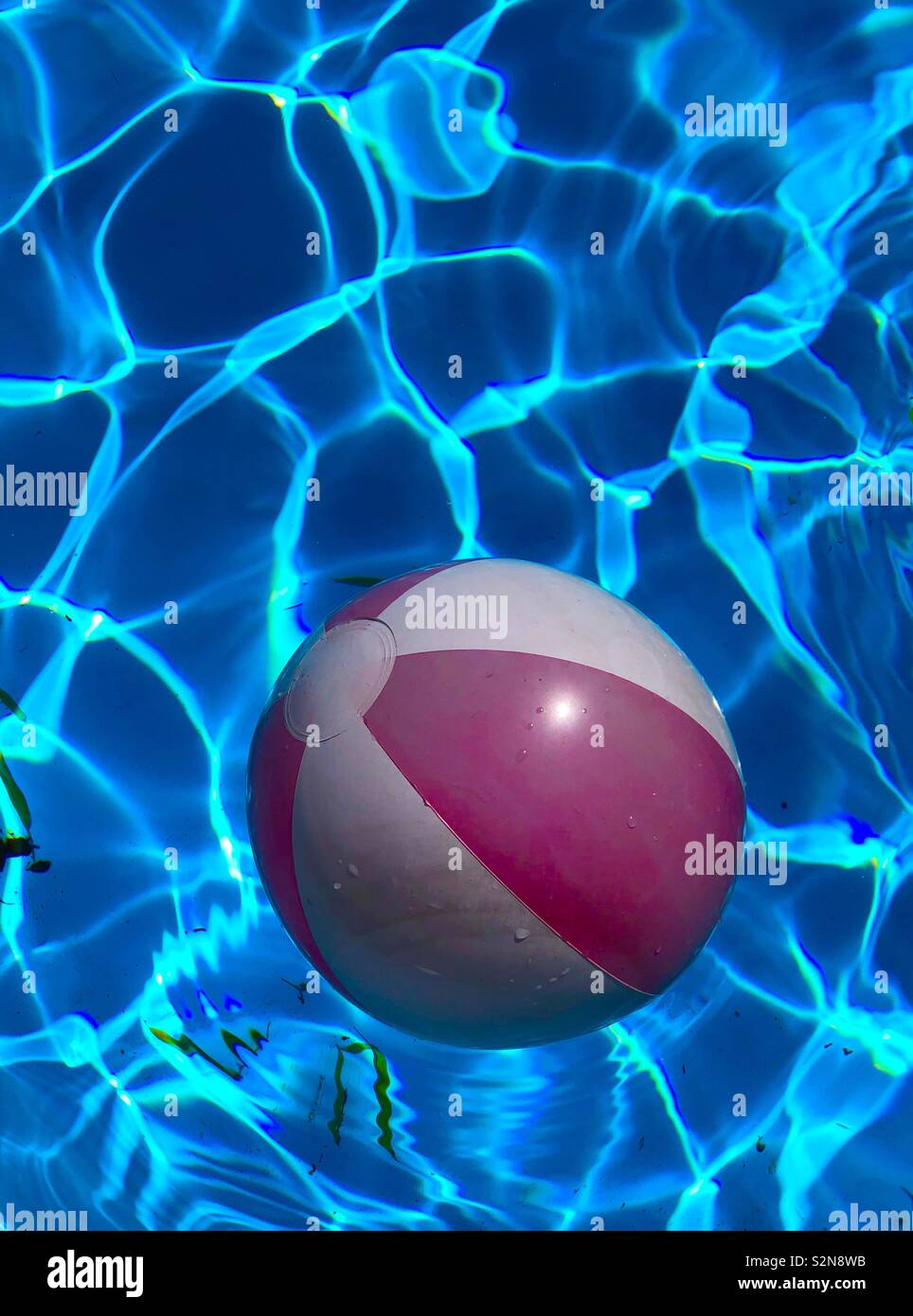 Ball floating in swimming pool Stock Photo - Alamy