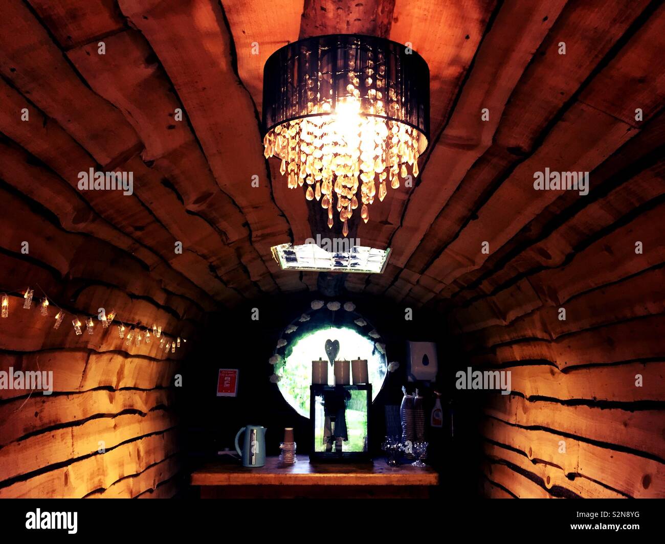Wooden hut with chandelier Stock Photo - Alamy