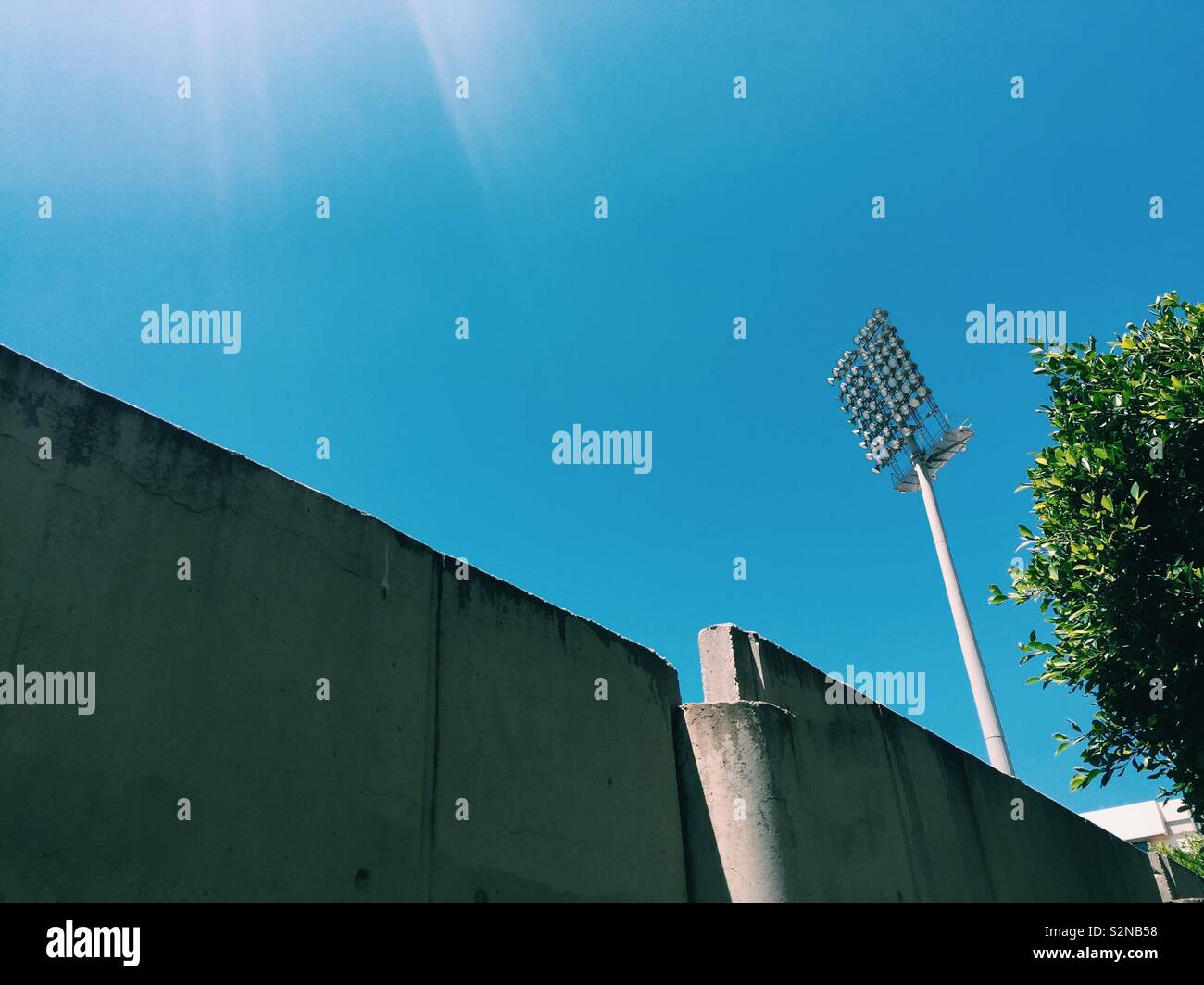 Football stadium lights at noon Stock Photo - Alamy