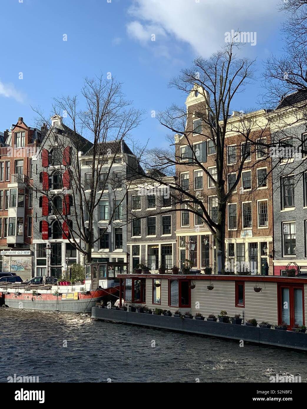 Canal view of colourful buildings in Amsterdam during February Stock ...