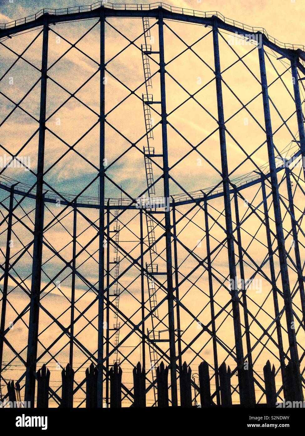 Close up of the intricate design of a gasometer silhouetted against the ...