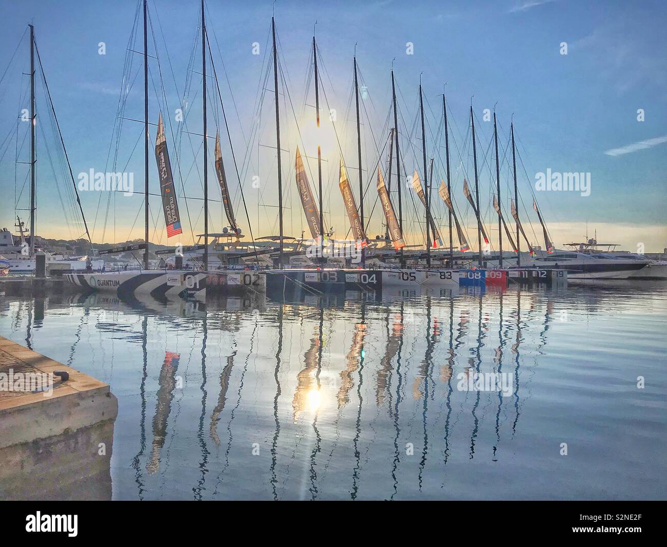 TP52 Super Series racing yachts moored in a line at Mahón harbour ...