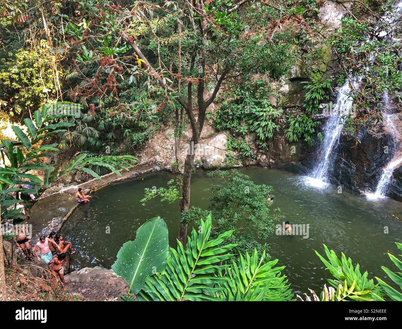 Taking a refreshing dip in the waterfall pool, Sierra Nevada, Colombia ...