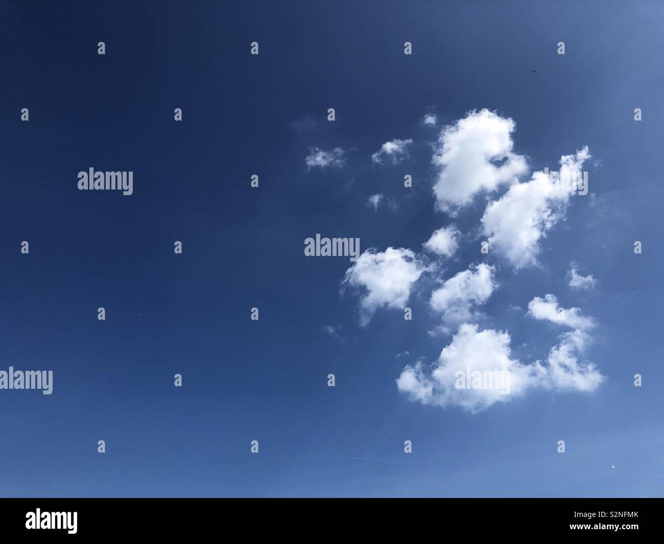 Wisps of white cloud in a blue sky Stock Photo - Alamy