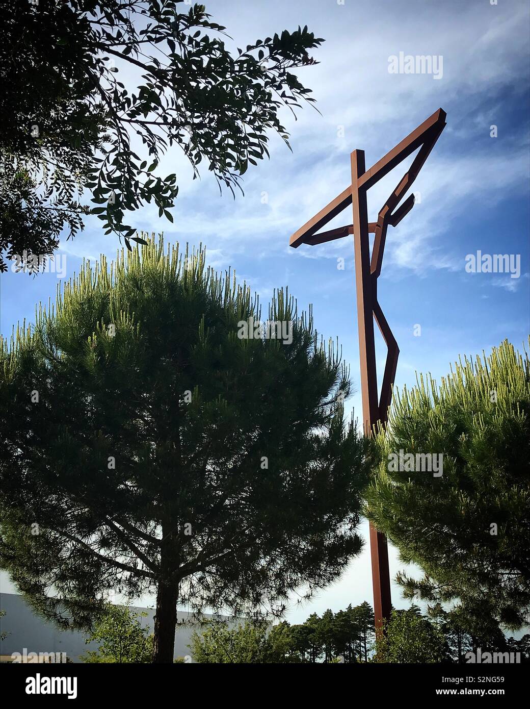 An image of Jesus Christ crucified and pine trees in Fatima, Portugal ...