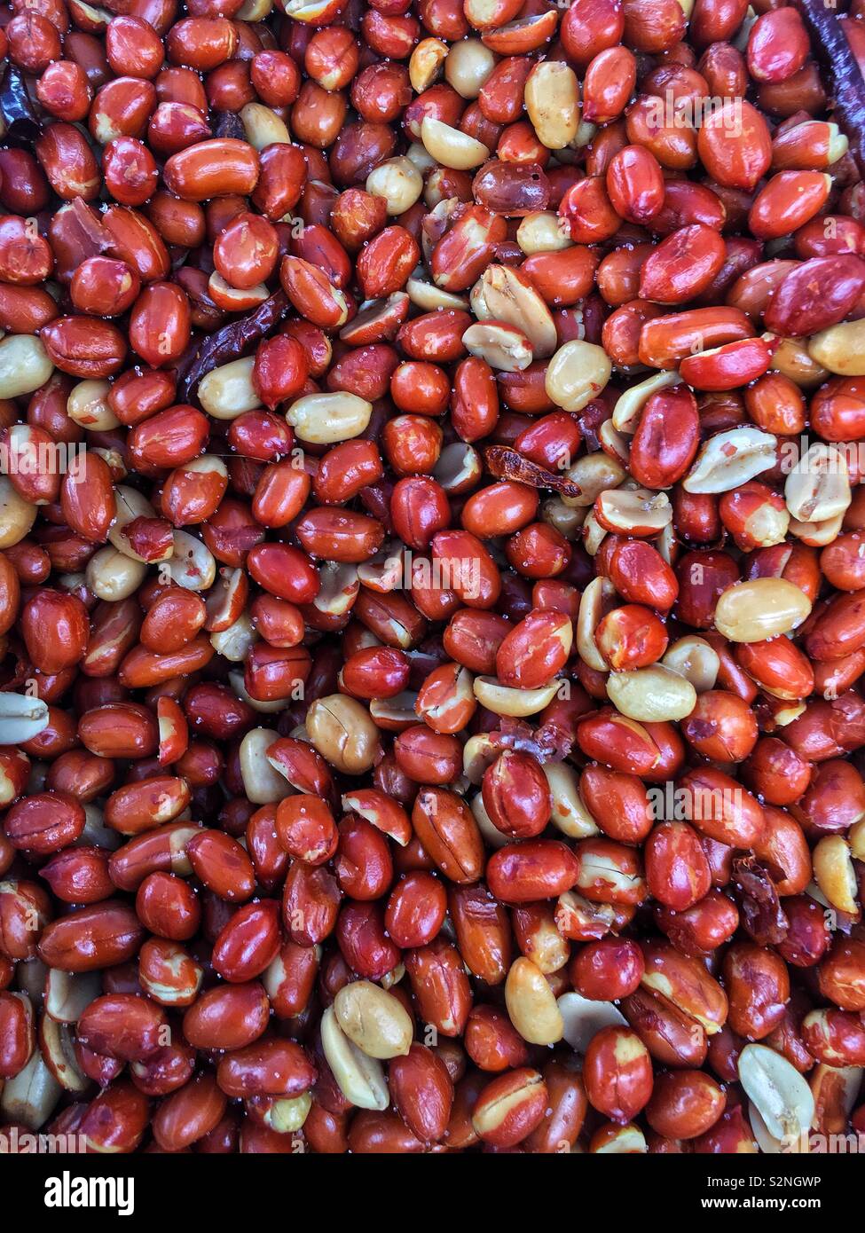 Full frame of fresh roasted Spanish peanuts tossed with hot chili ...