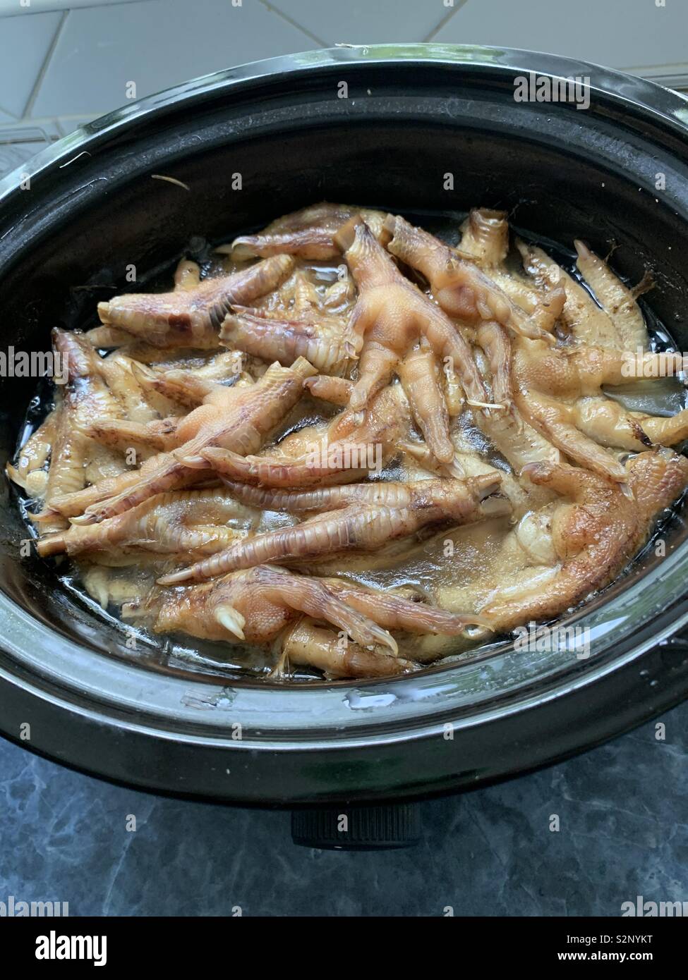 Chicken feet cooking Stock Photo - Alamy