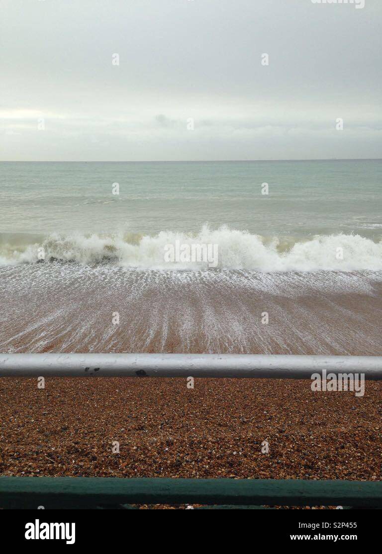 Brighton beach. Tide going out caught at moment wave breaks Stock Photo ...