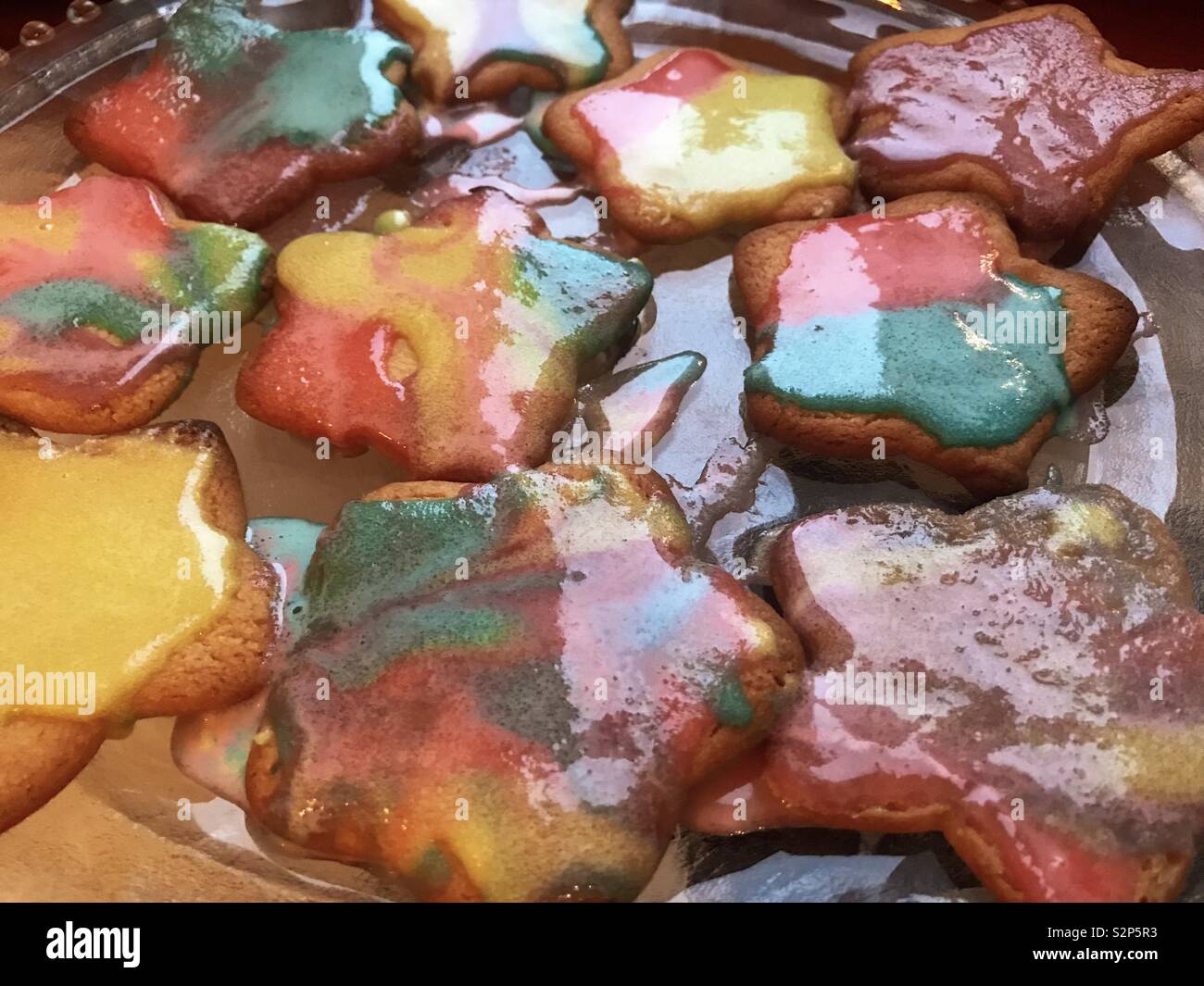 Multi colored cookies drying after icing Stock Photo - Alamy