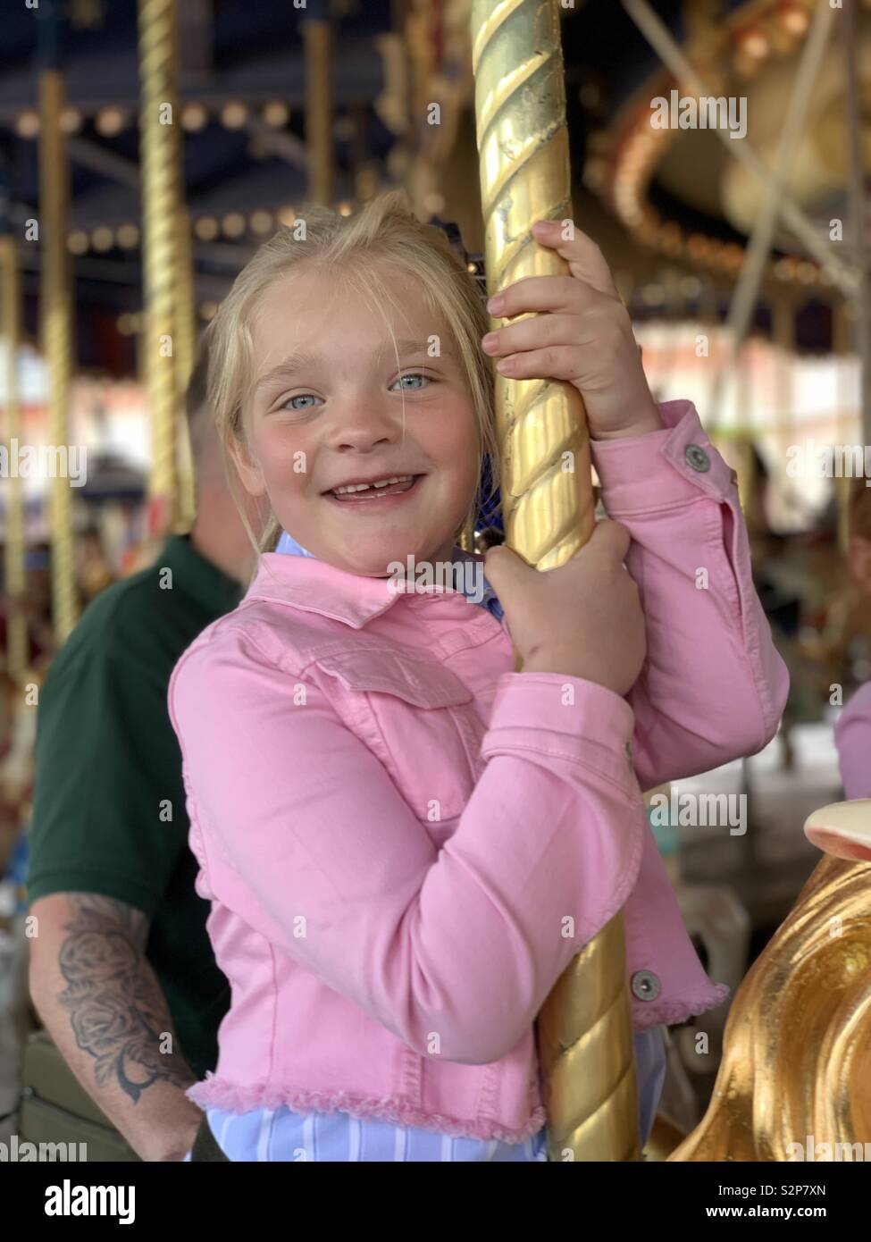Girl on carousel Stock Photo - Alamy