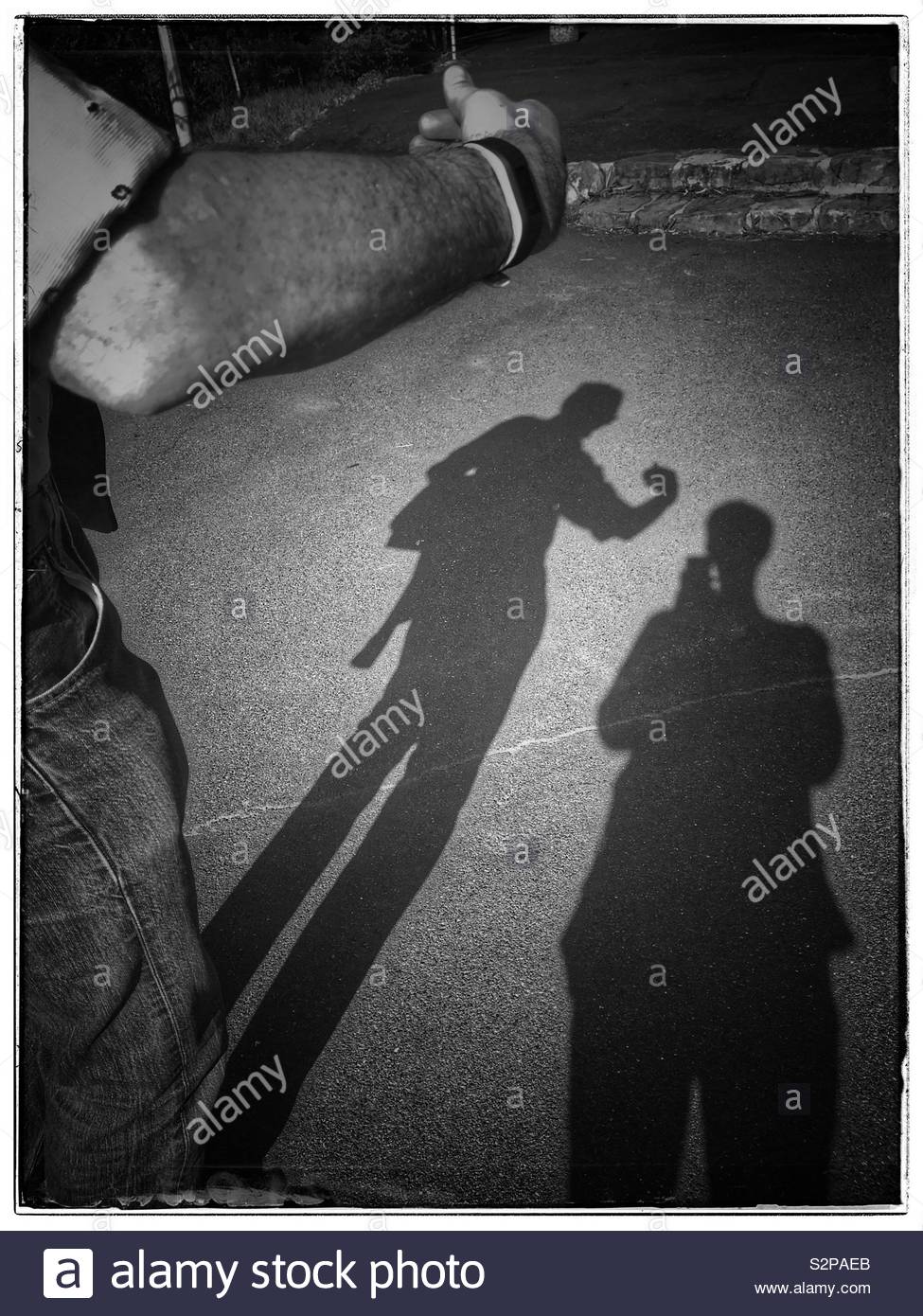 Man’s arm and two shadowy figures Stock Photo - Alamy