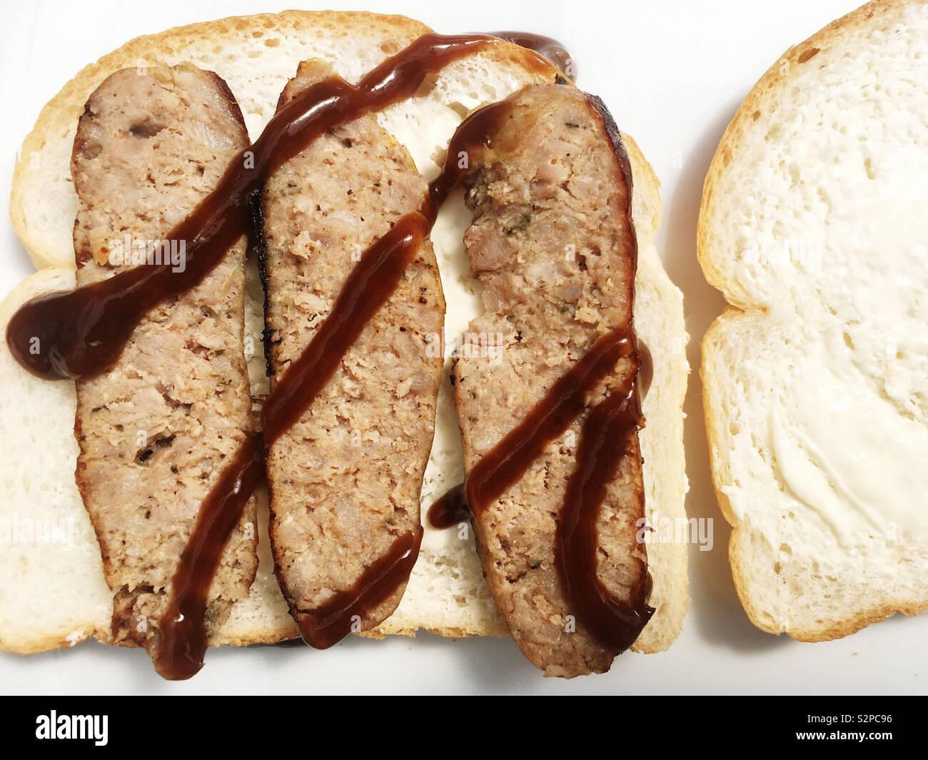 Sausage sandwich with brown sauce Stock Photo - Alamy
