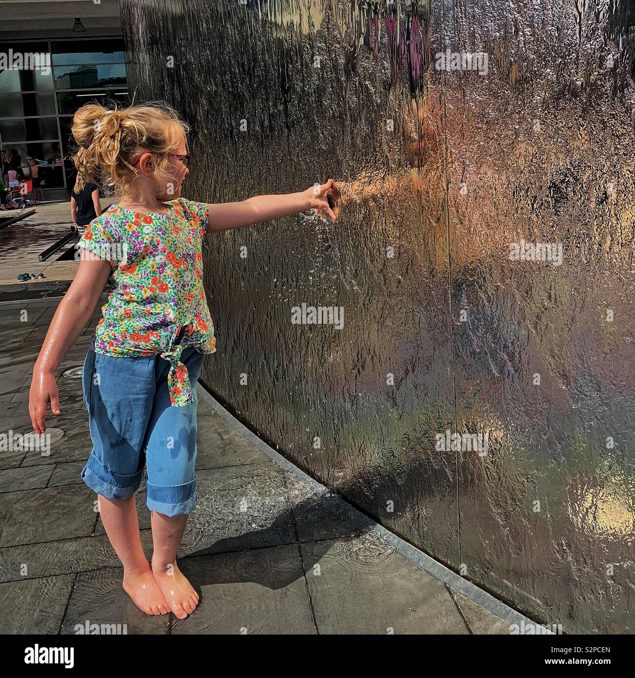 Summer waterfall fun Stock Photo - Alamy