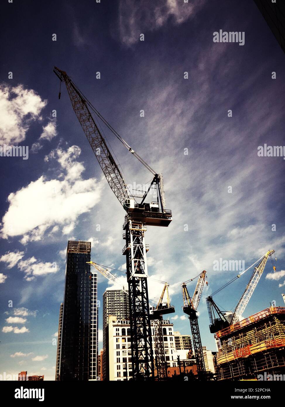 Cranes at a high-rise construction site near Hudson yards, NYC, USA ...
