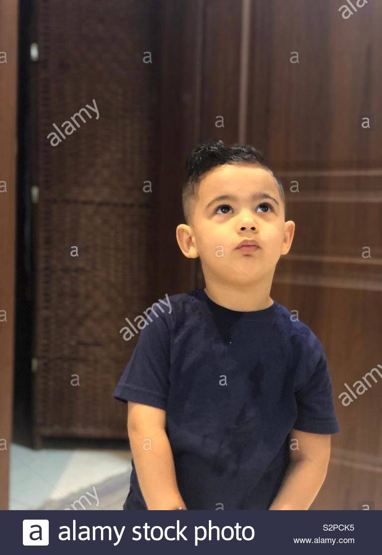 My cute son taking a professional pose Stock Photo - Alamy