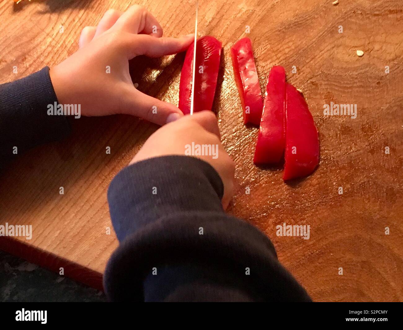 Child cutting pepper hi-res stock photography and images - Alamy