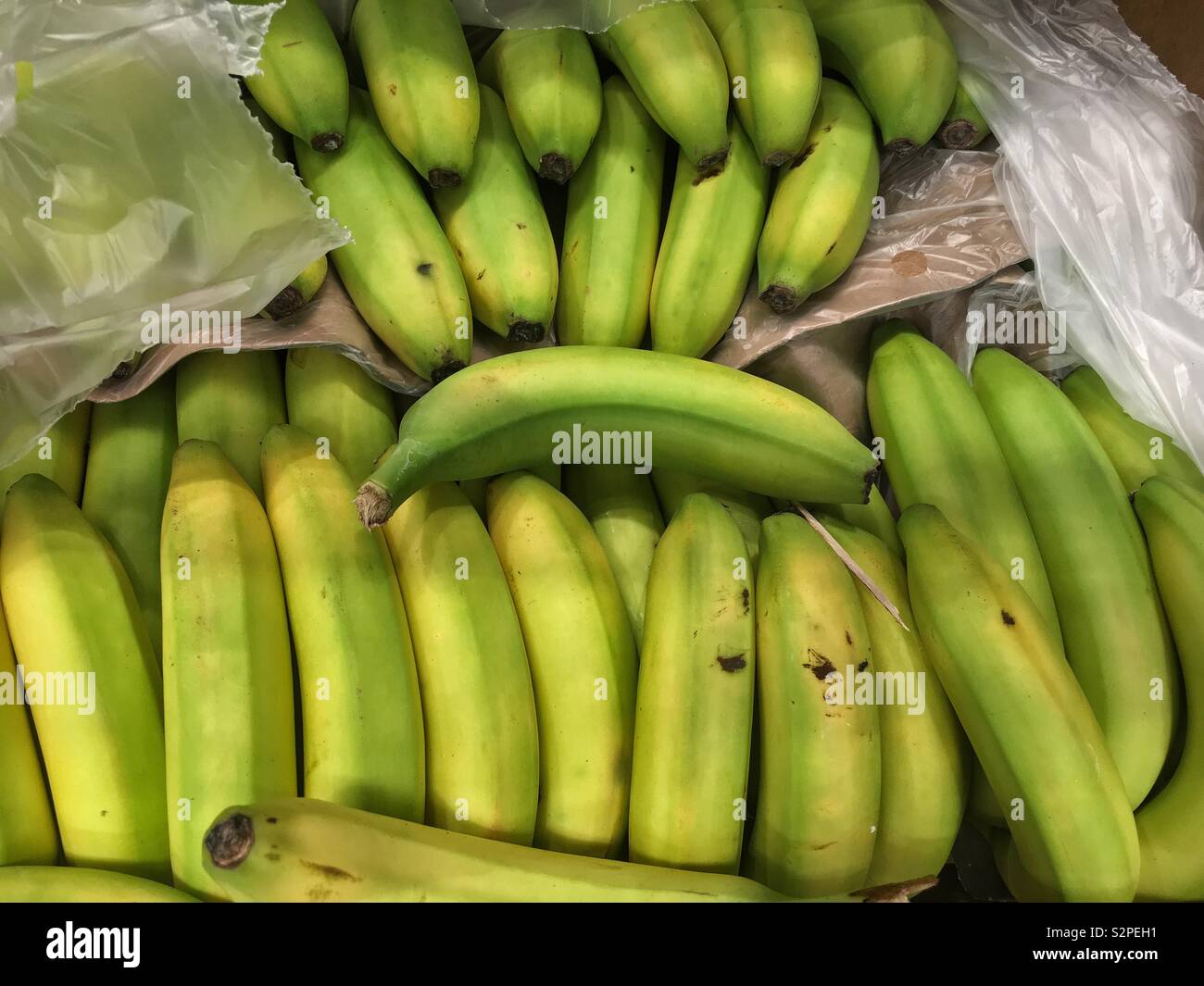 Perfectly ripe bunch of bananas piled in a box Stock Photo - Alamy