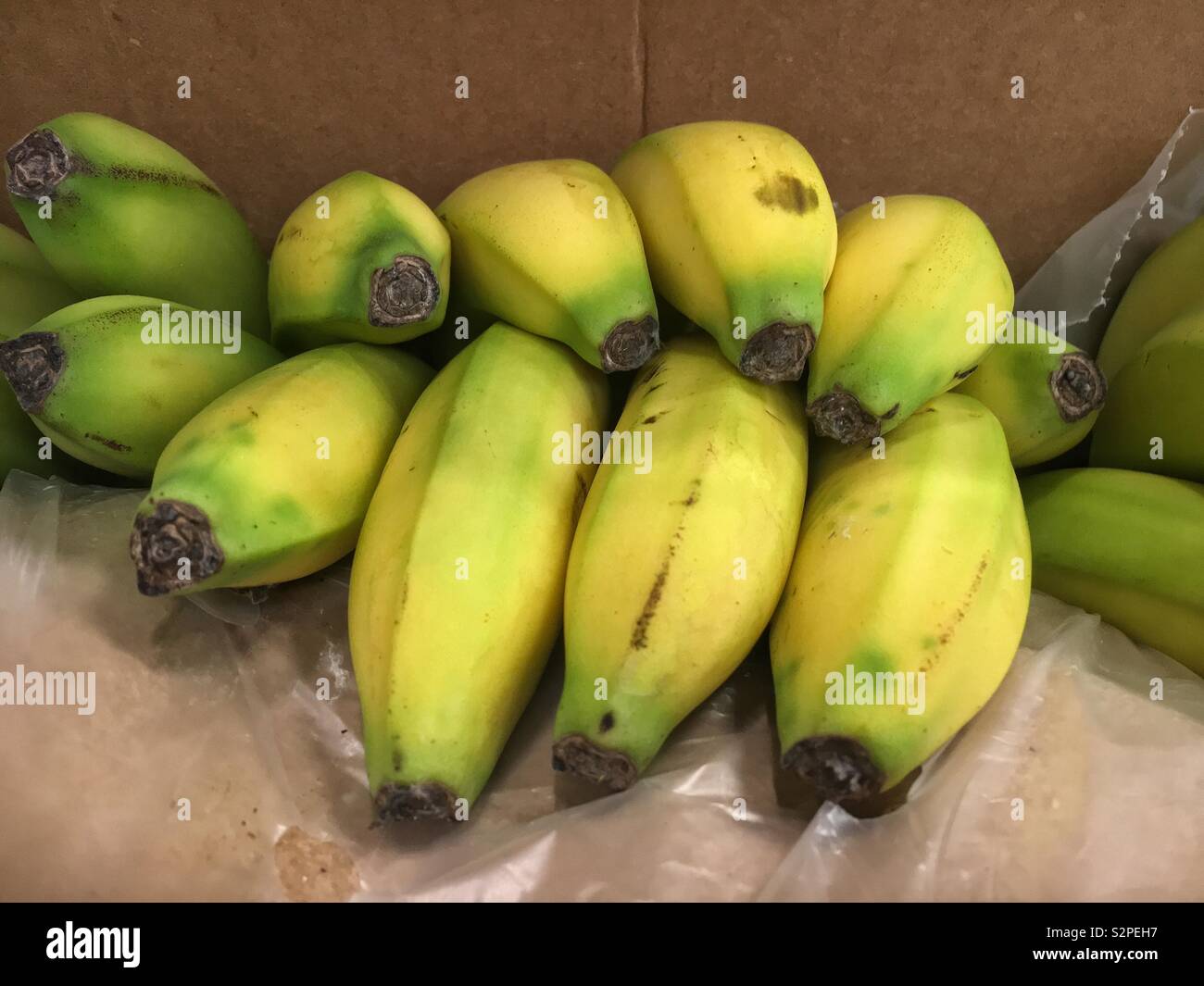 Perfectly ripe bunch of bananas piled in a box Stock Photo - Alamy