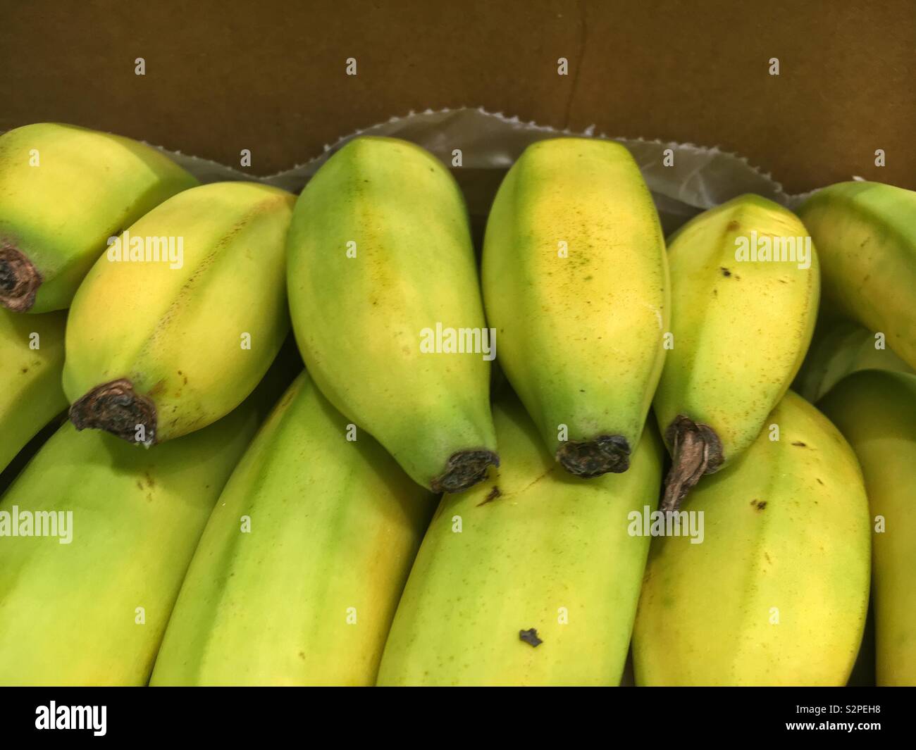 Perfectly ripe bunch of bananas piled in a box Stock Photo - Alamy