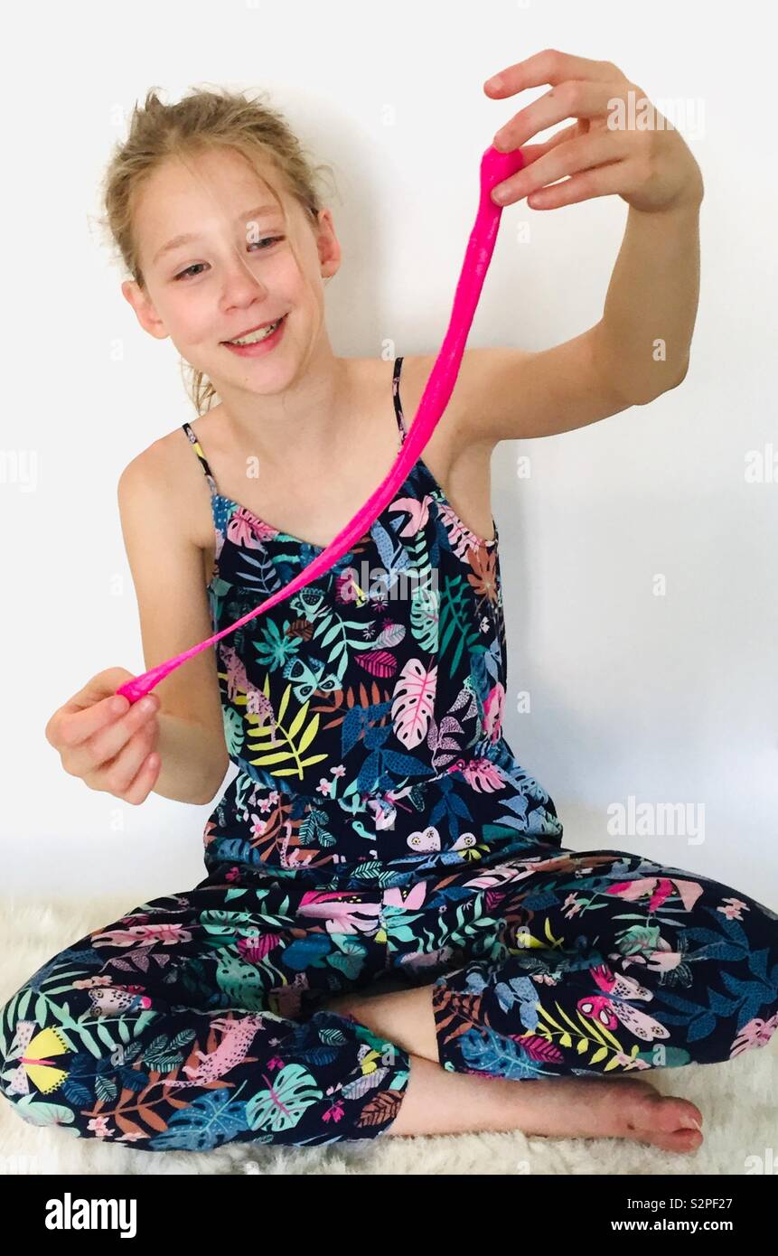 Girl playing with slime Stock Photo - Alamy