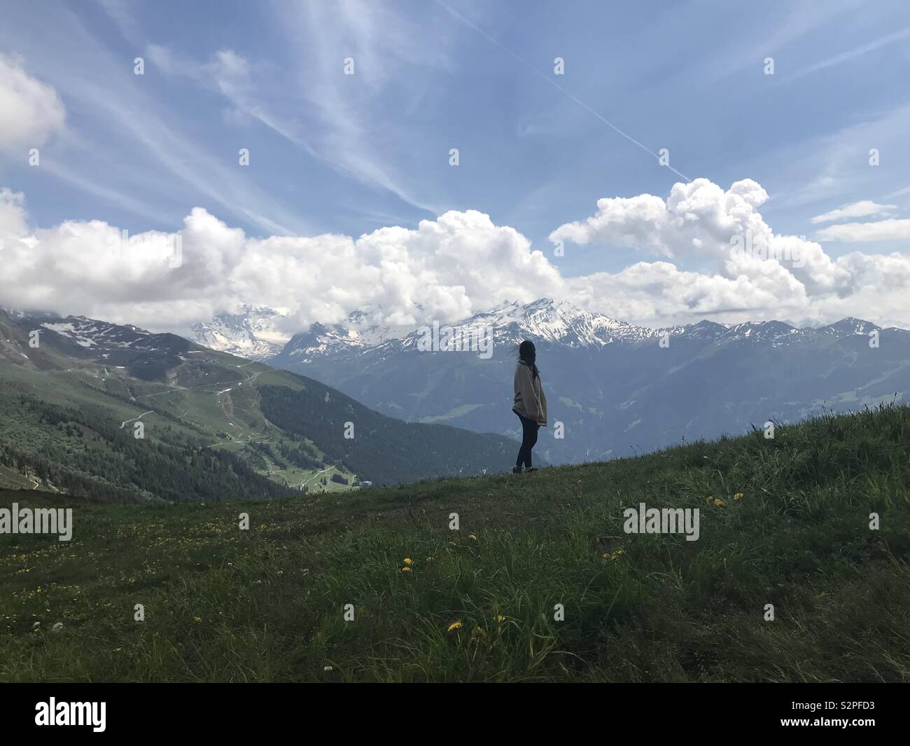 Woman looking over a valley in the Swiss alps Stock Photo - Alamy