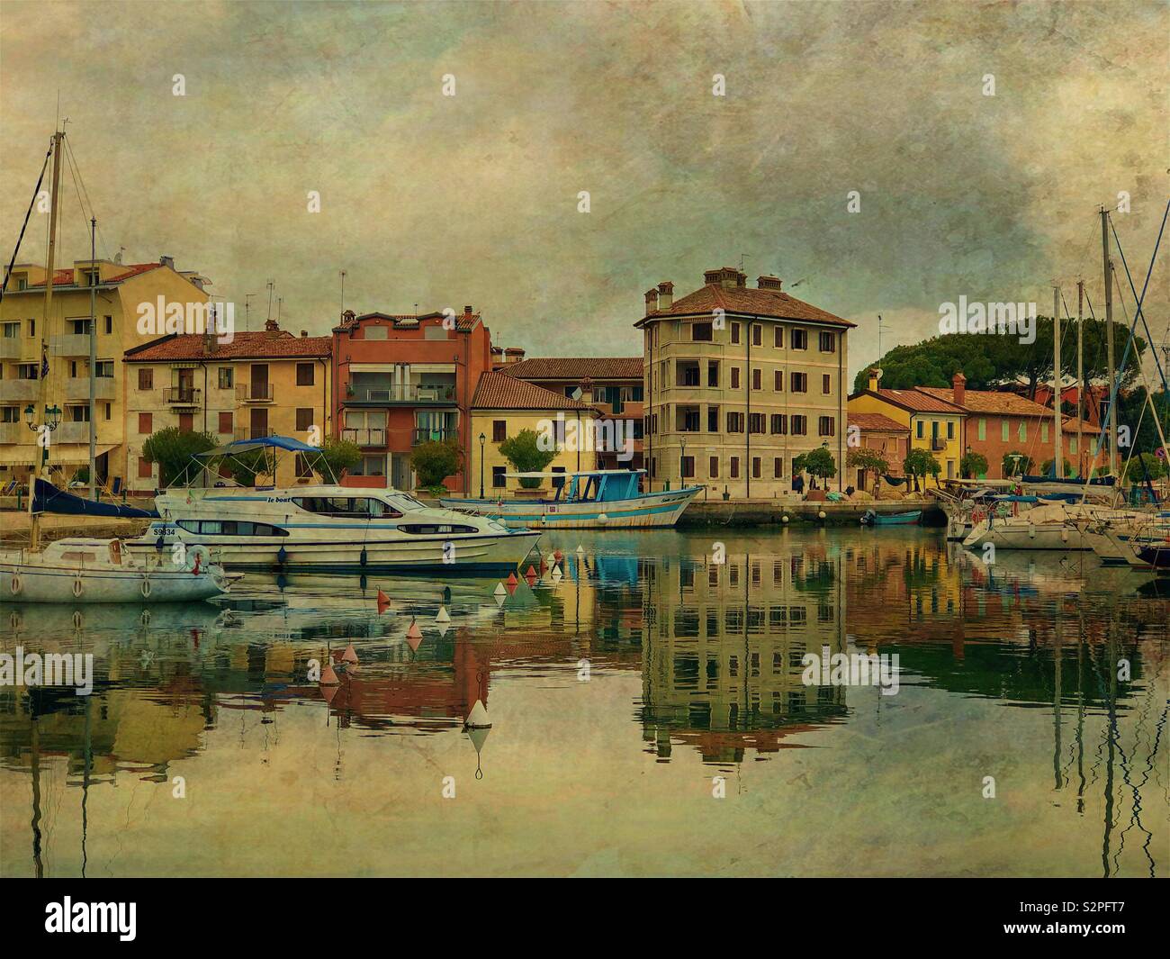 Buildings and boats reflecting in Grado canal - Grado, Friuli Venezia ...
