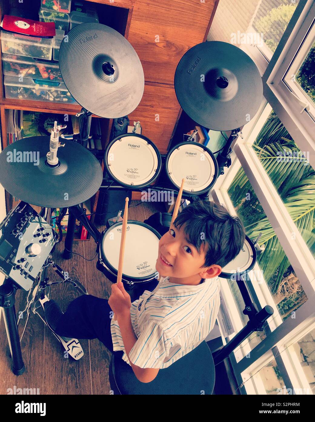 Young boy playing electronic drums or electronic battery Stock Photo ...