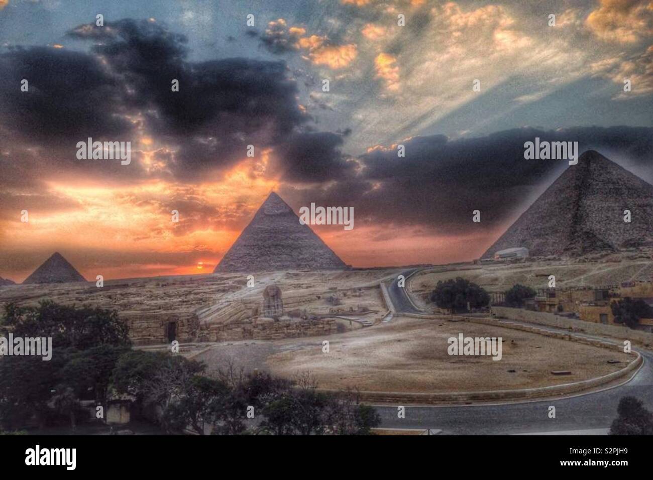 Sunset behind the Pyramids of Giza and Sphinx Stock Photo - Alamy