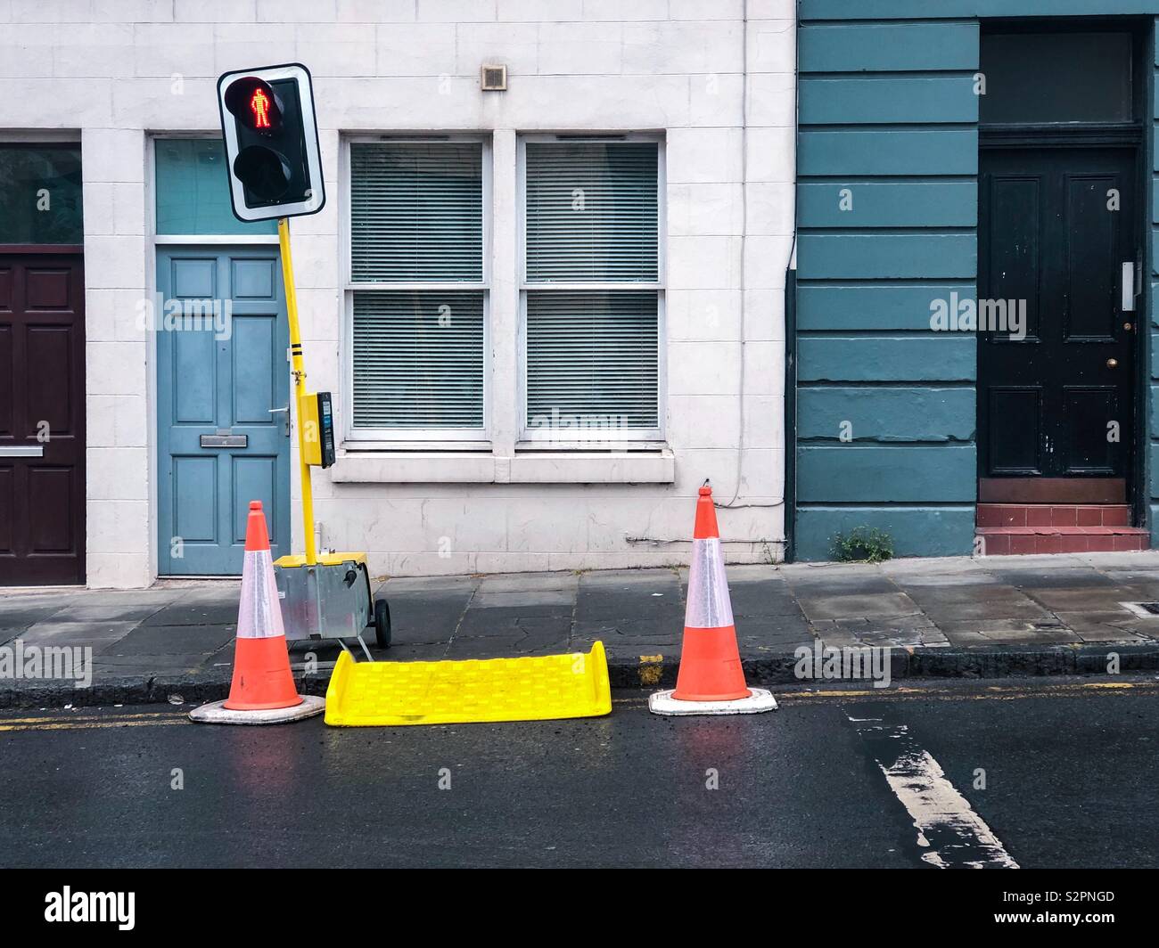 A temporary pedestrian crossing in front of tenement blocks in ...