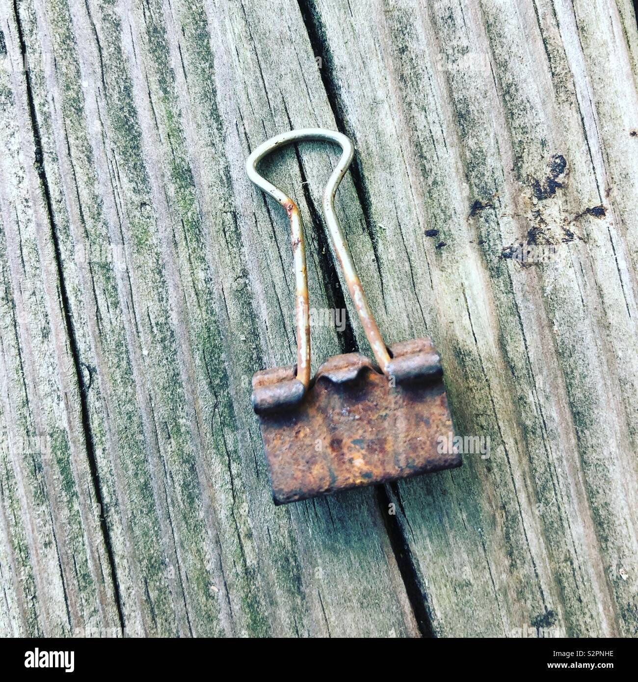 Rusty clip on a park bench Stock Photo - Alamy