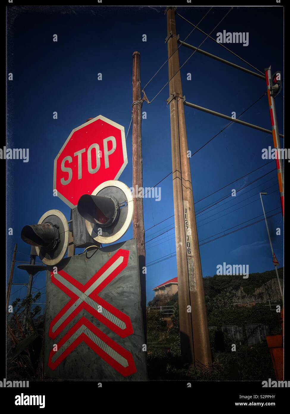 Stop sign at railway crossing Stock Photo - Alamy