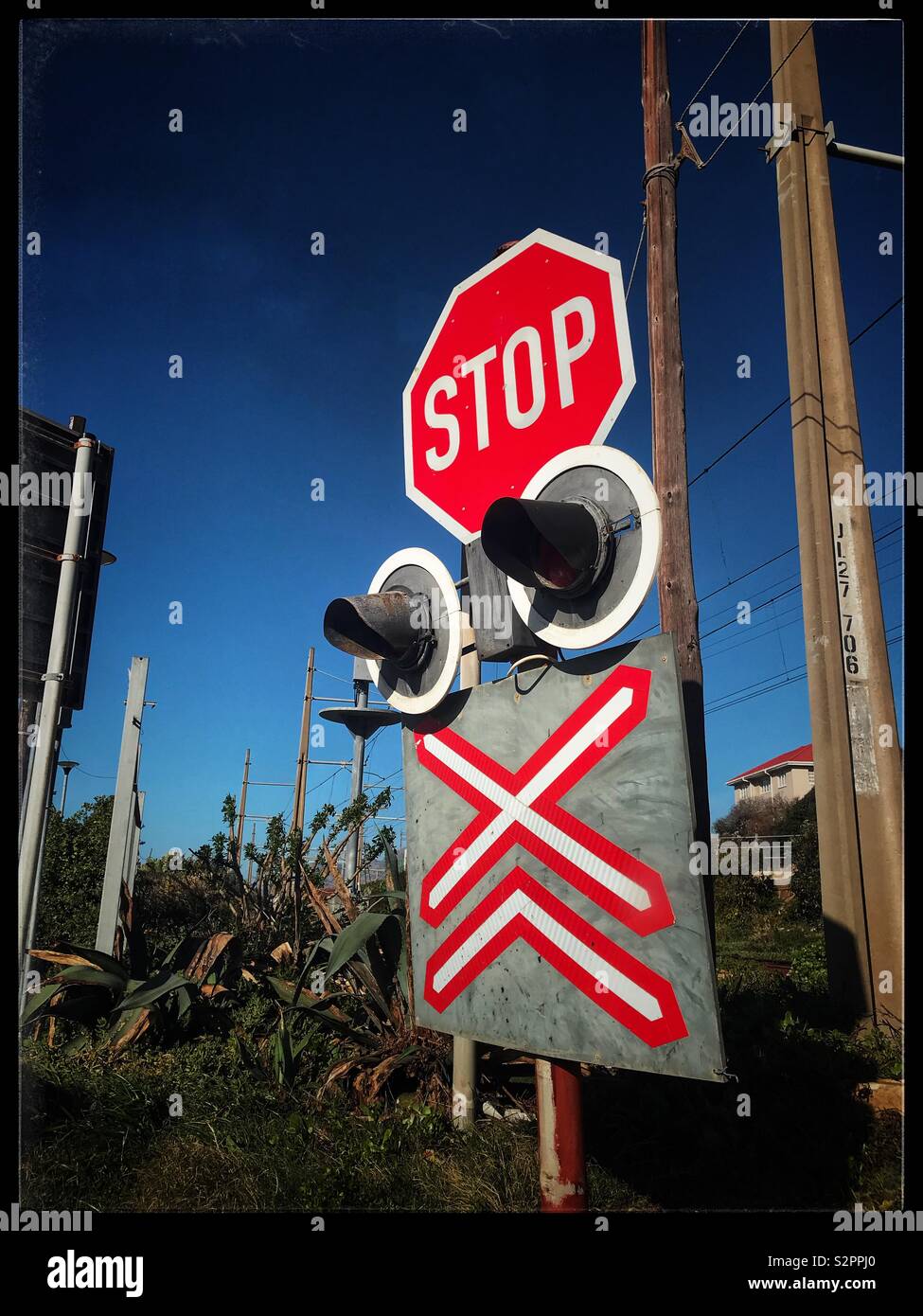 Stop sign at railway crossing Stock Photo - Alamy