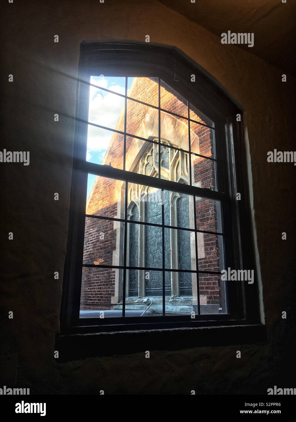 View of a stained glass church window from a rectory window Stock Photo ...