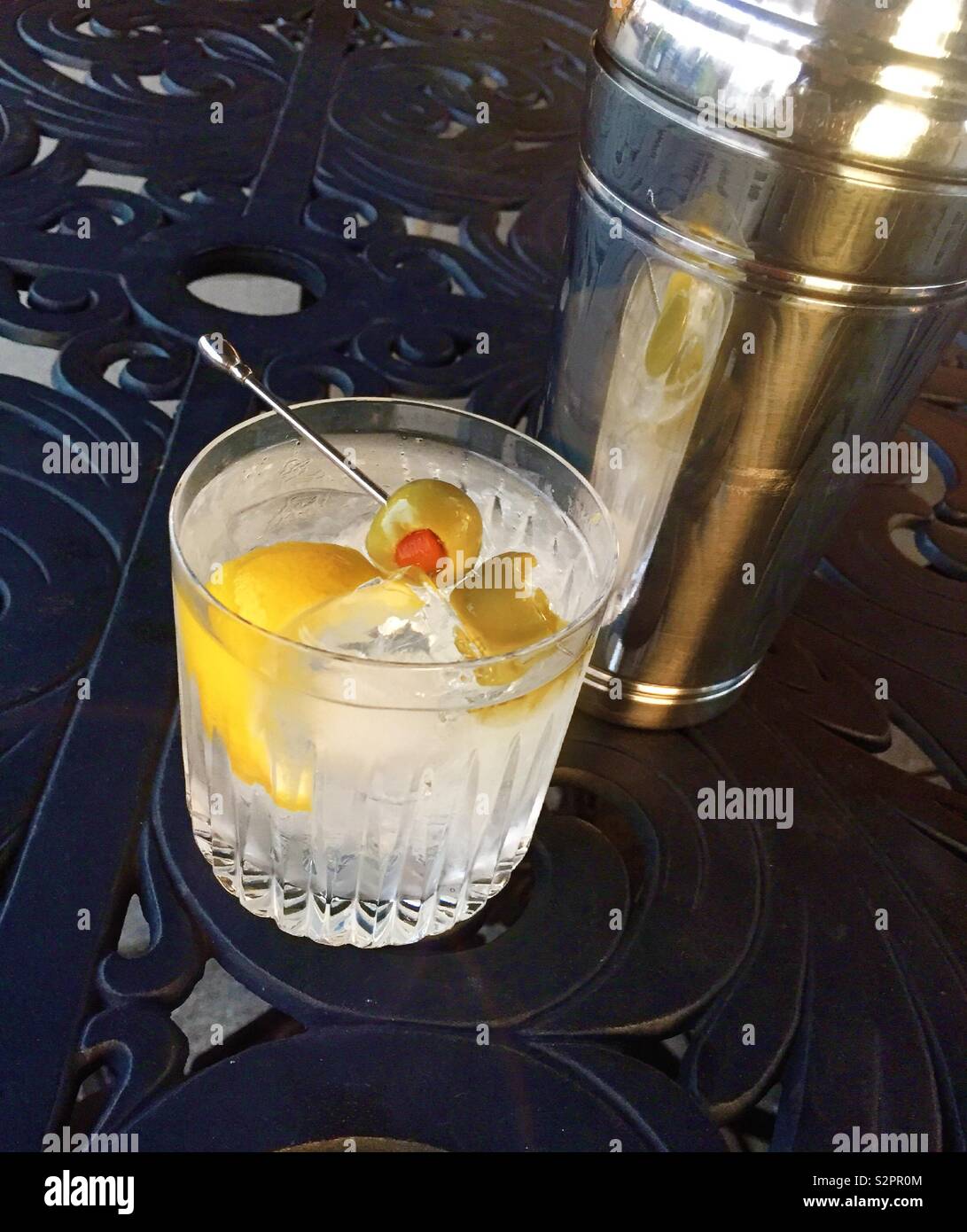 A martini cocktail on the rocks in a crystal glass next to cocktail ...