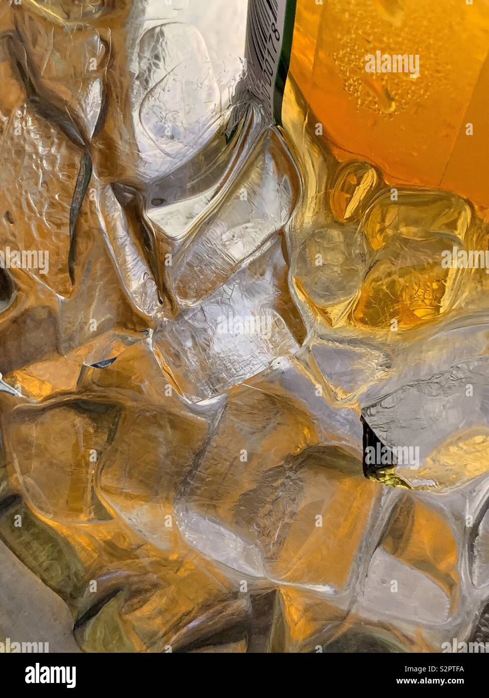 Abstract of ice cubes in a bucket reflecting color of drinks Stock ...